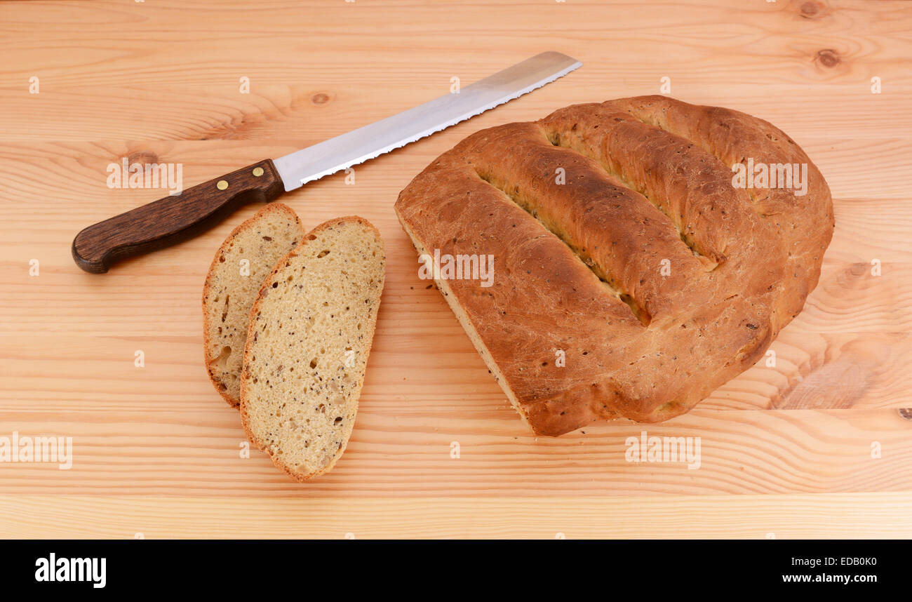 Slices cut from a multi seed malted loaf with a sharp bread knife on a ...