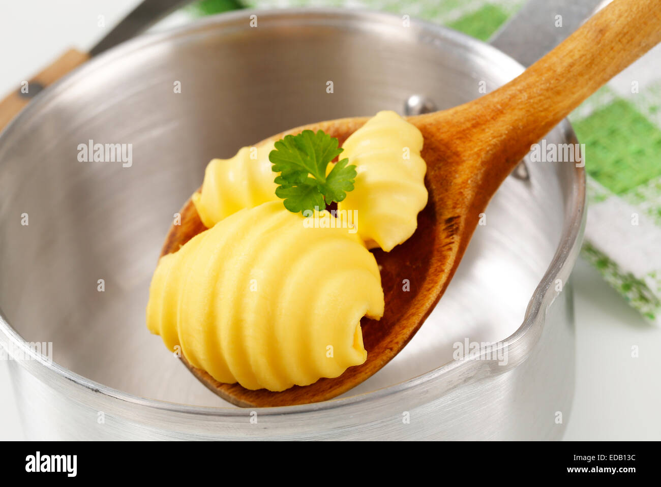 Butter curls on wooden spoon and saucepan Stock Photo - Alamy