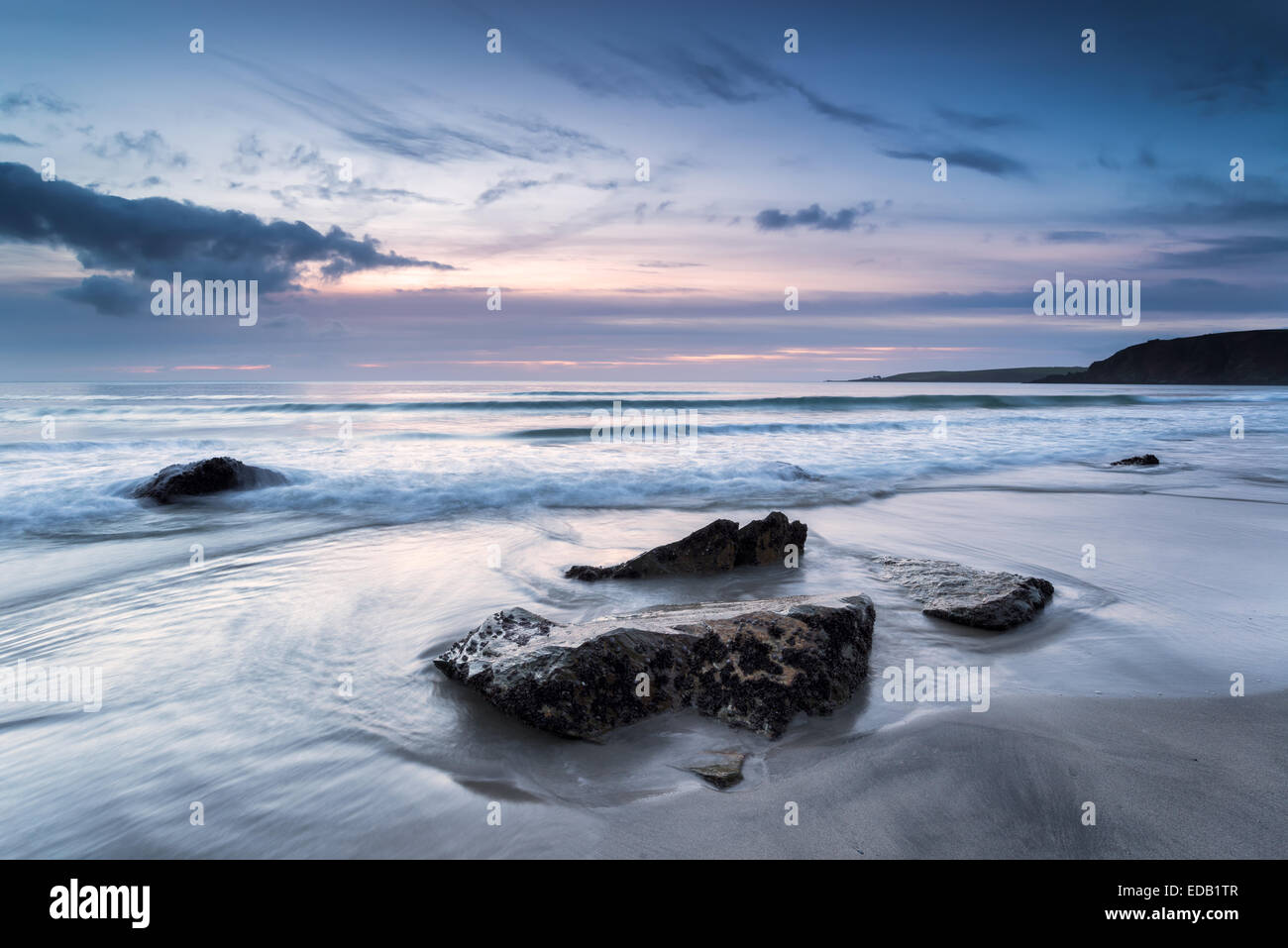 Rocks and waves at Pentewan Sands beach on the south coast of Cornwall ...