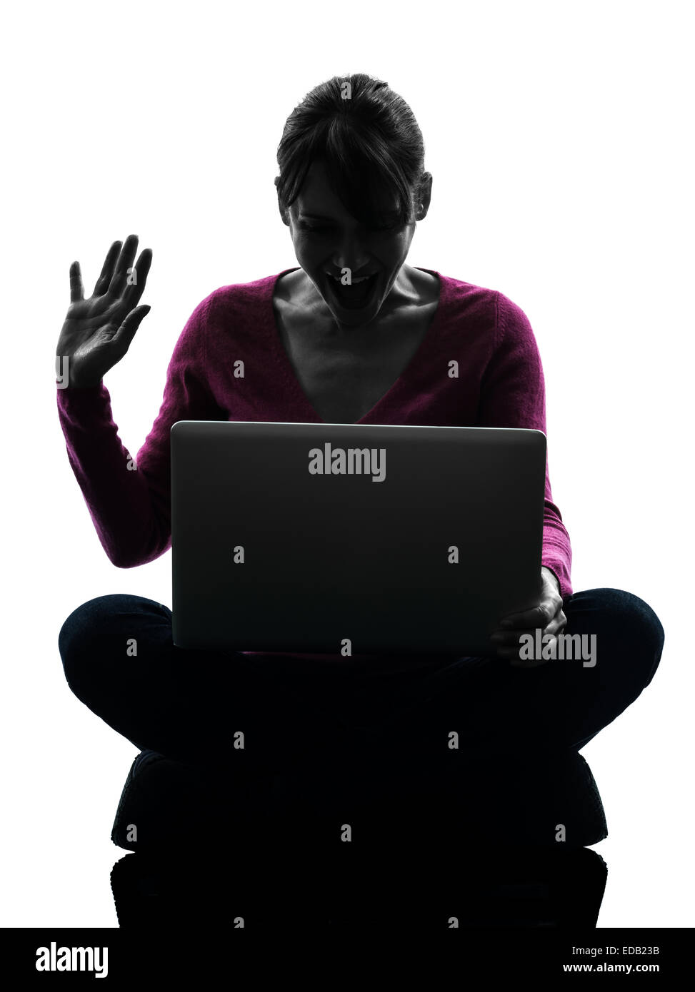 one woman saluting computing laptop computer in silhouette studio ...