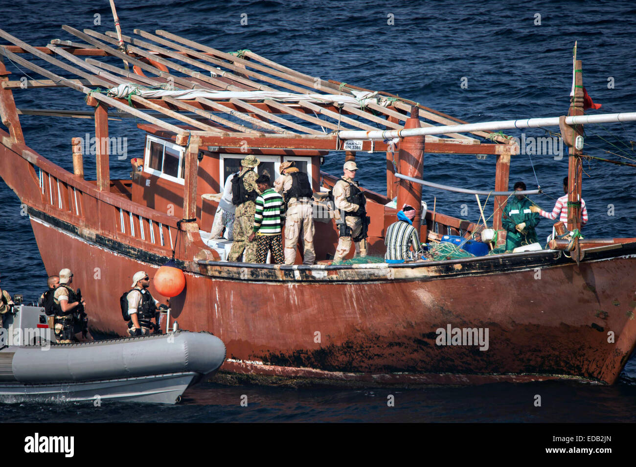 A US Navy commandos with a Visit, board, search and seizure team talk ...
