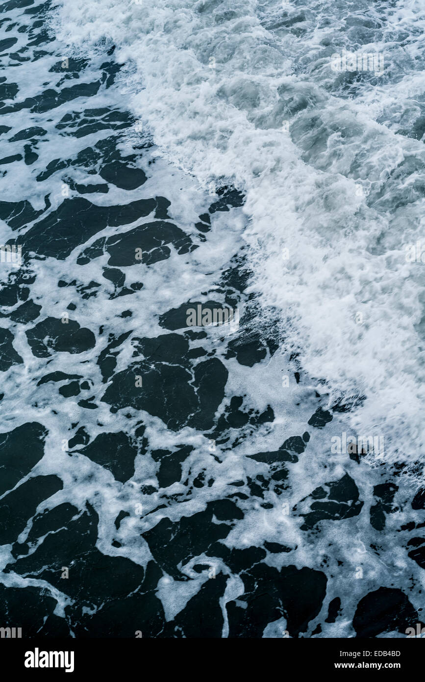 Image of waves crashing on the shore creating abstract patterns Stock ...