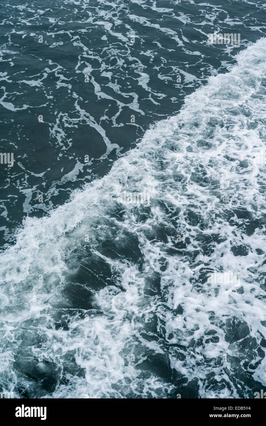 waves create abstract patterns as they break on the shore Stock Photo ...