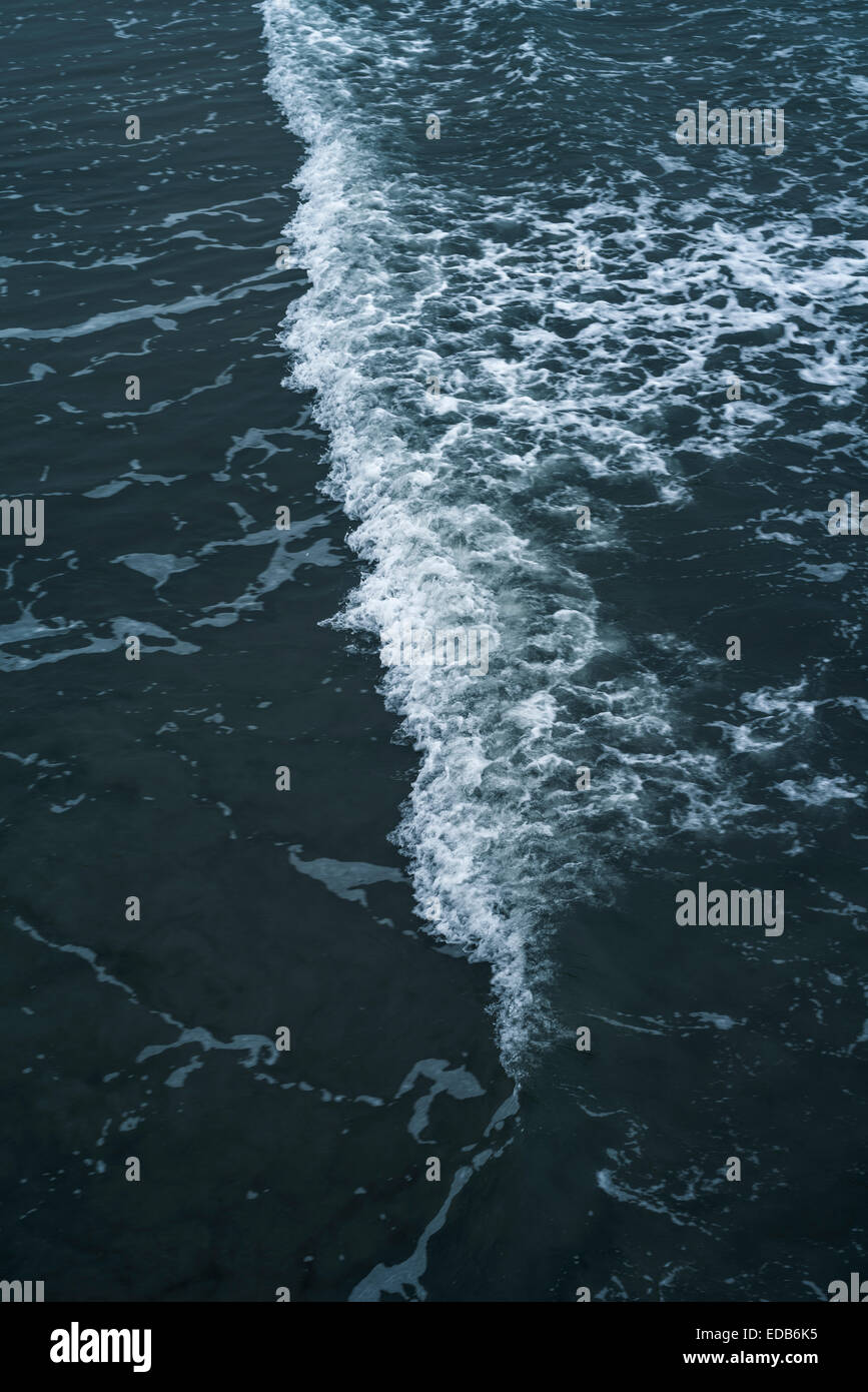 waves create abstract patterns as they break on the shore Stock Photo ...