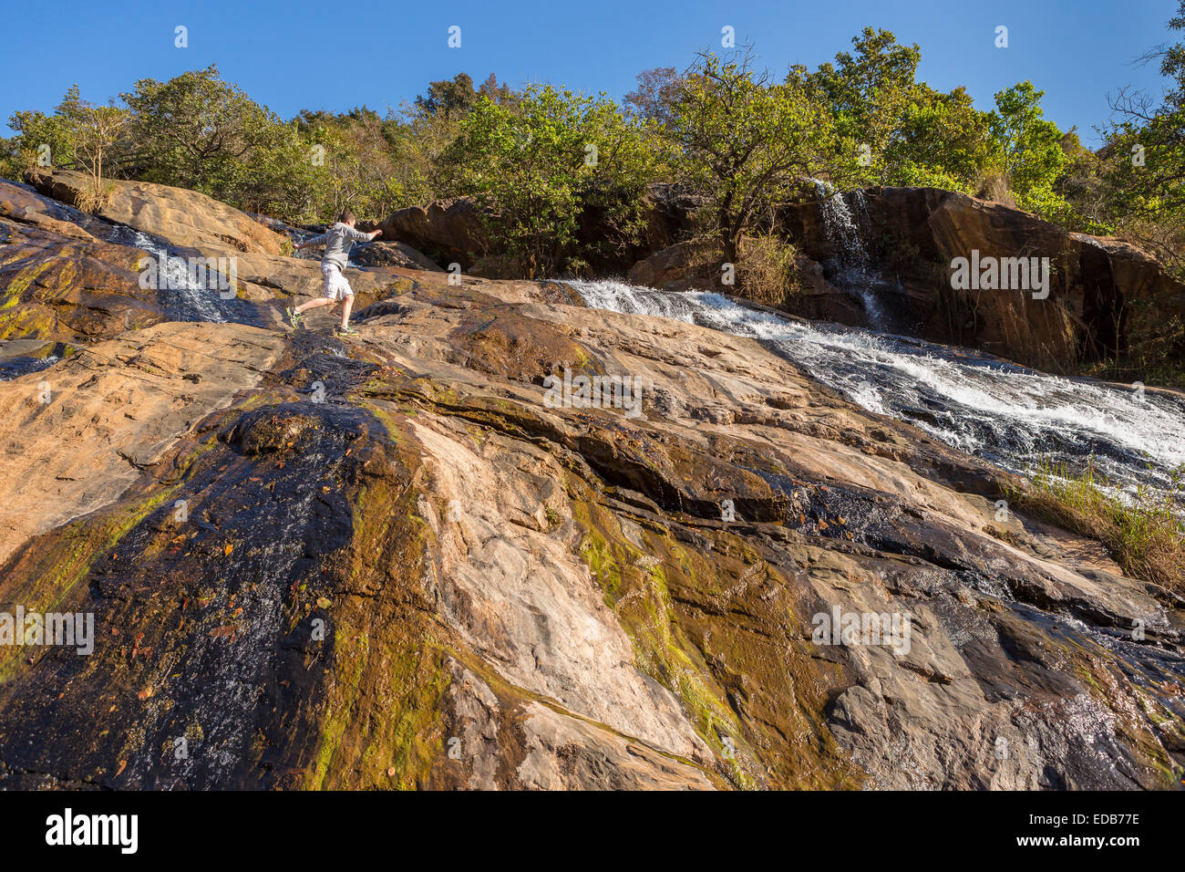 HHOHHO, SWAZILAND, AFRICA - Hiker jumps over water at Phophonyane ...