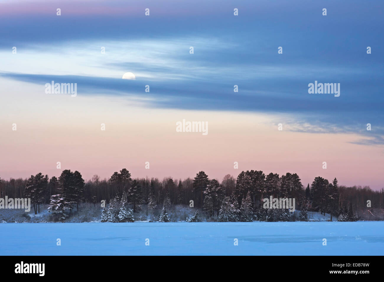 Frozen winter lake, snow, ice and moon with clouds in Northern ...