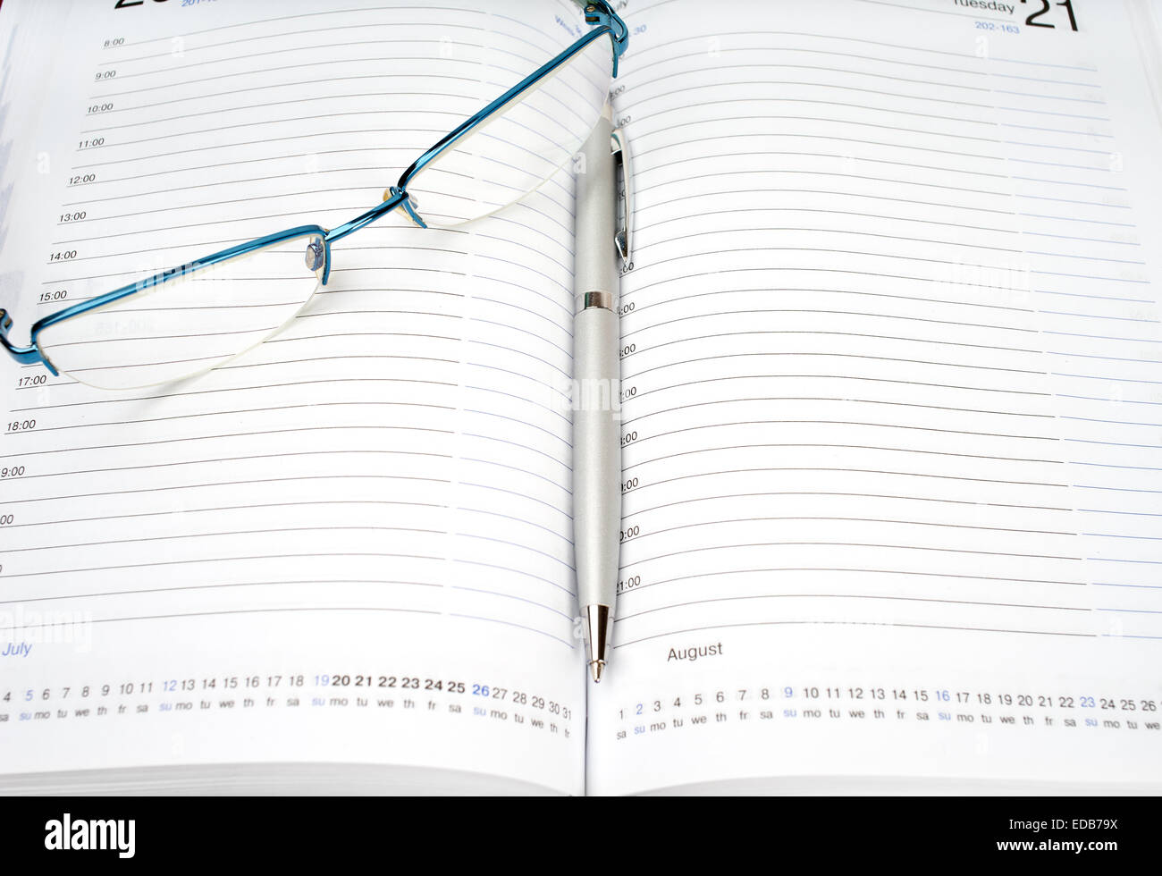 Daily planner with glasses and pen on the table Stock Photo - Alamy
