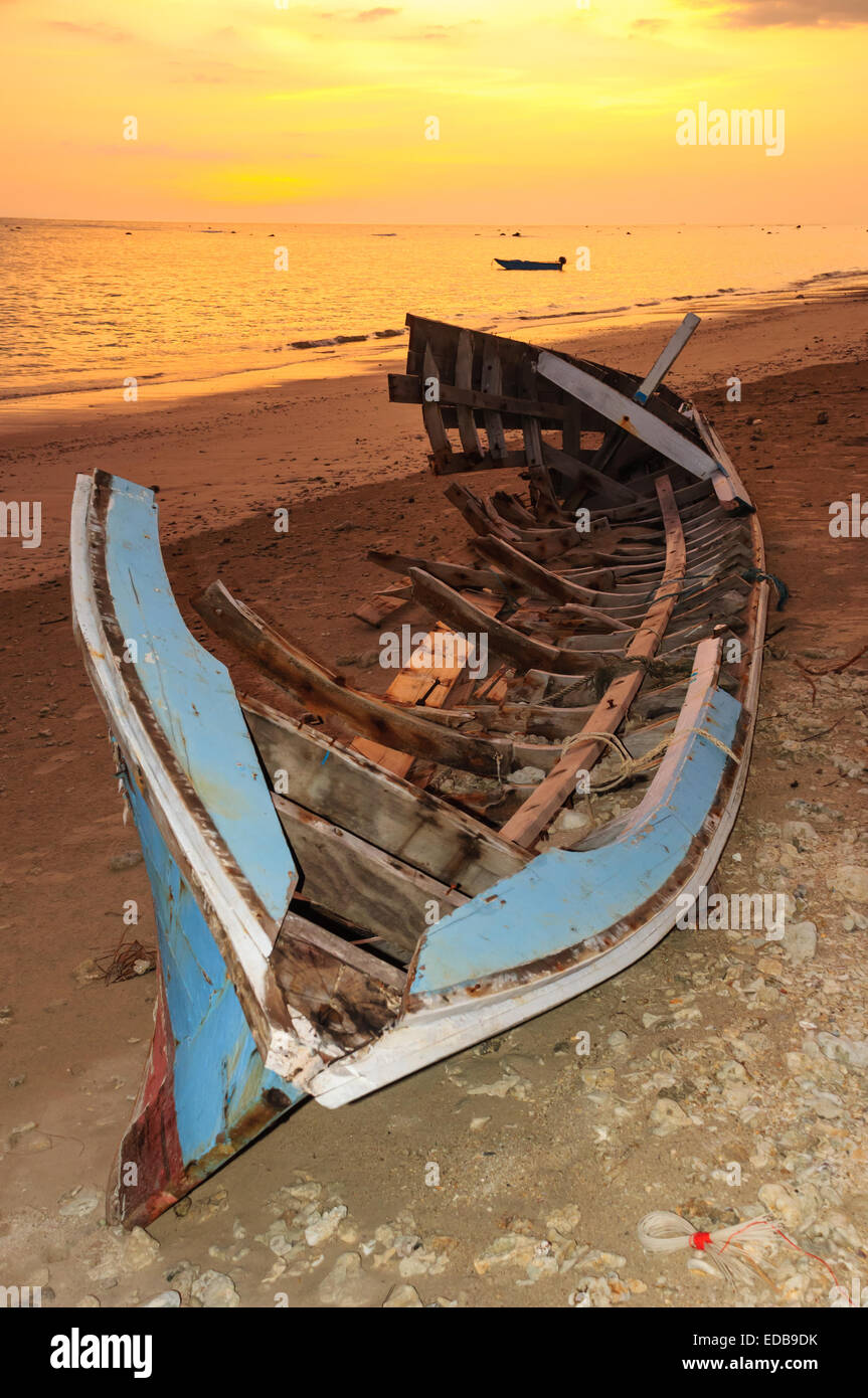 Boat at beach and sunset Stock Photo - Alamy