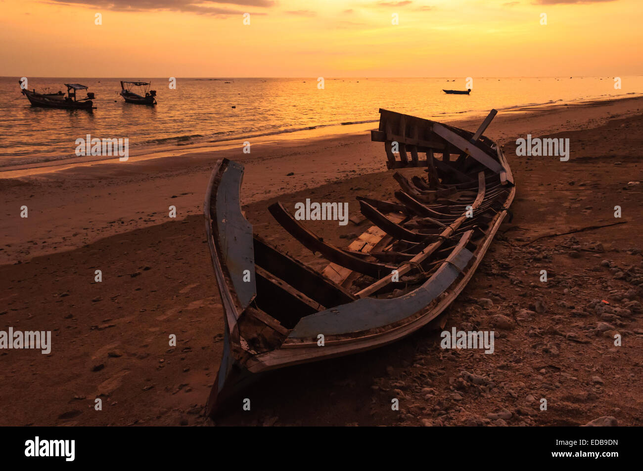 Boat at beach and sunset Stock Photo - Alamy