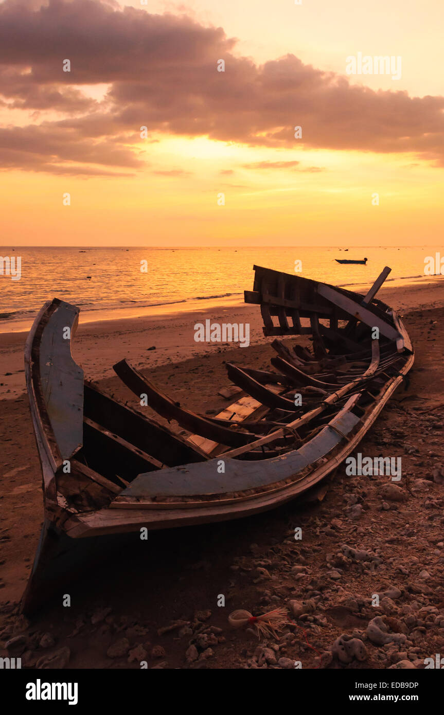 Boat at beach and sunset Stock Photo - Alamy