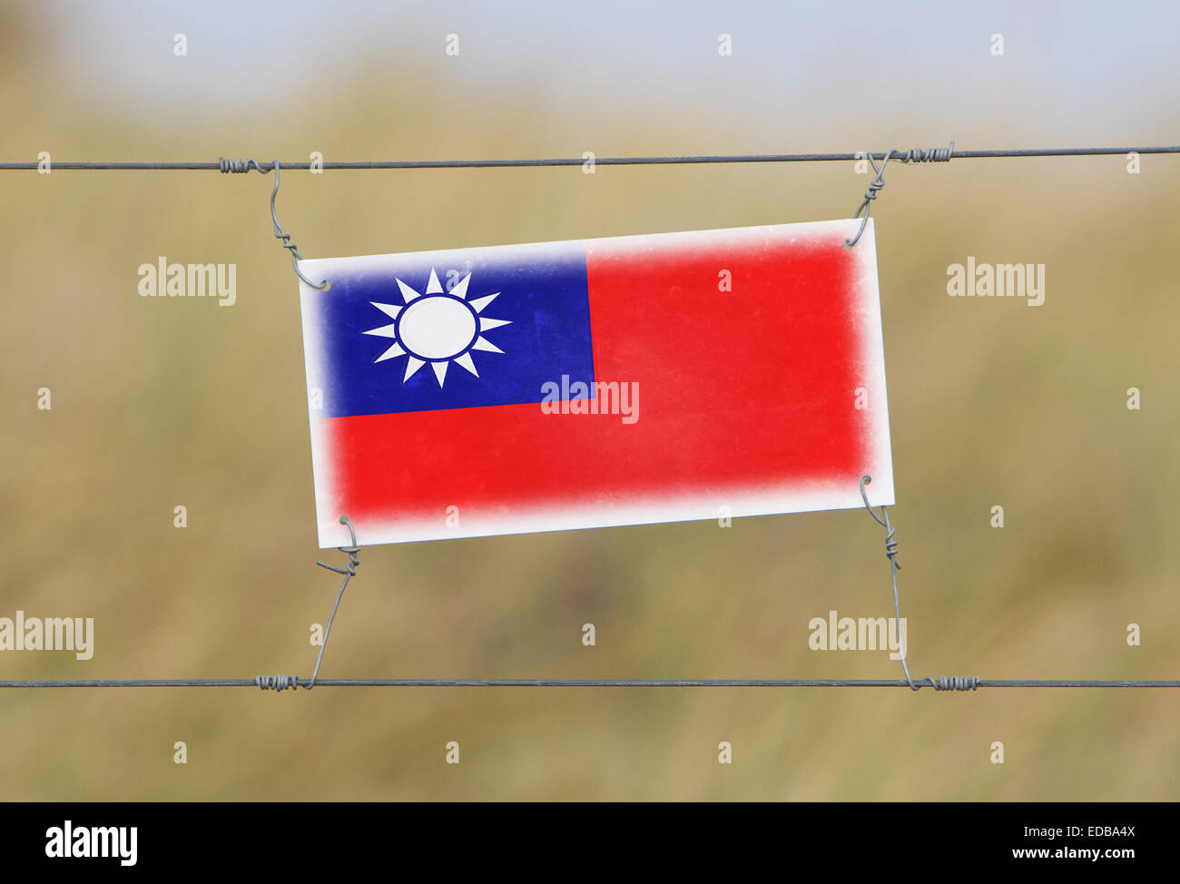 Border fence - Old plastic sign with a flag - Taiwan Stock Photo - Alamy