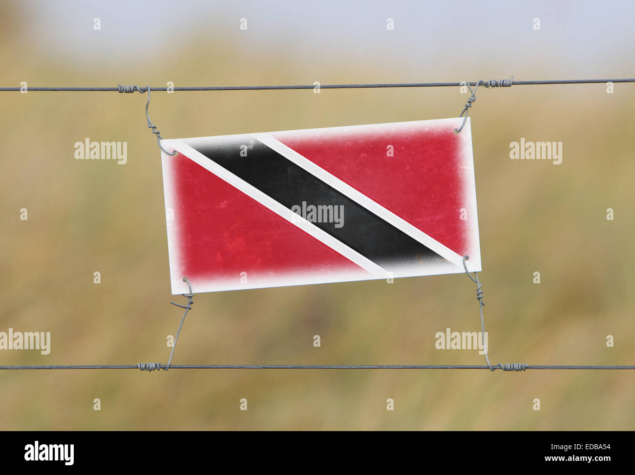 Border fence - Old plastic sign with a flag - Trinidad and Tobago Stock ...