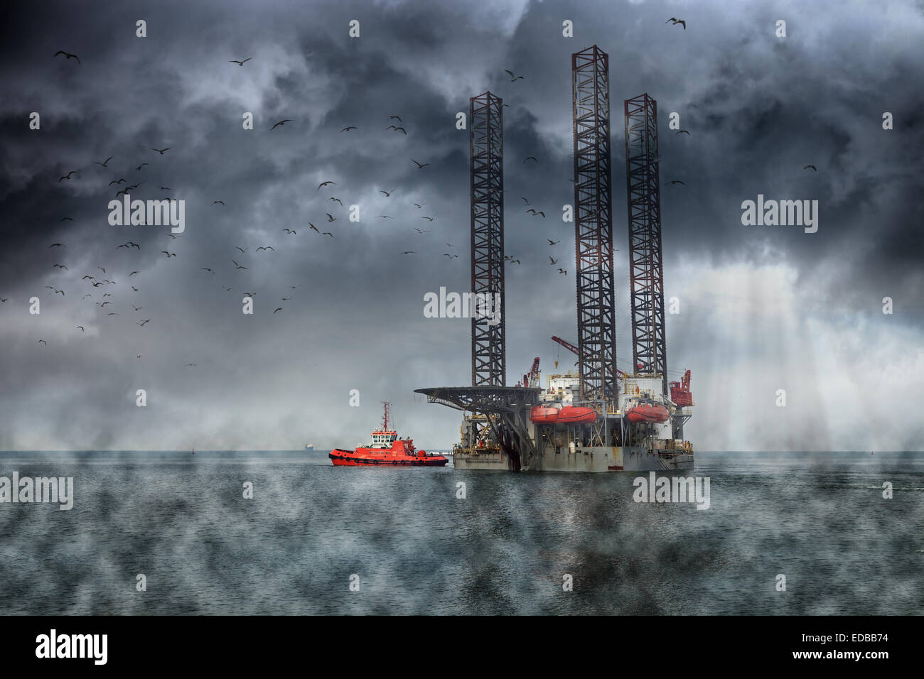 Oil Rig at sea on a dark cloudy dramatic sky Stock Photo - Alamy