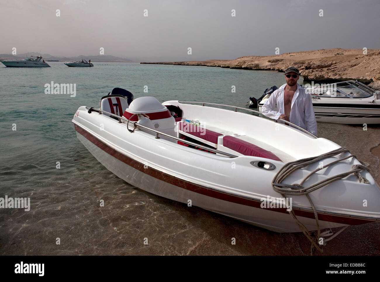 Captain and boat Stock Photo - Alamy