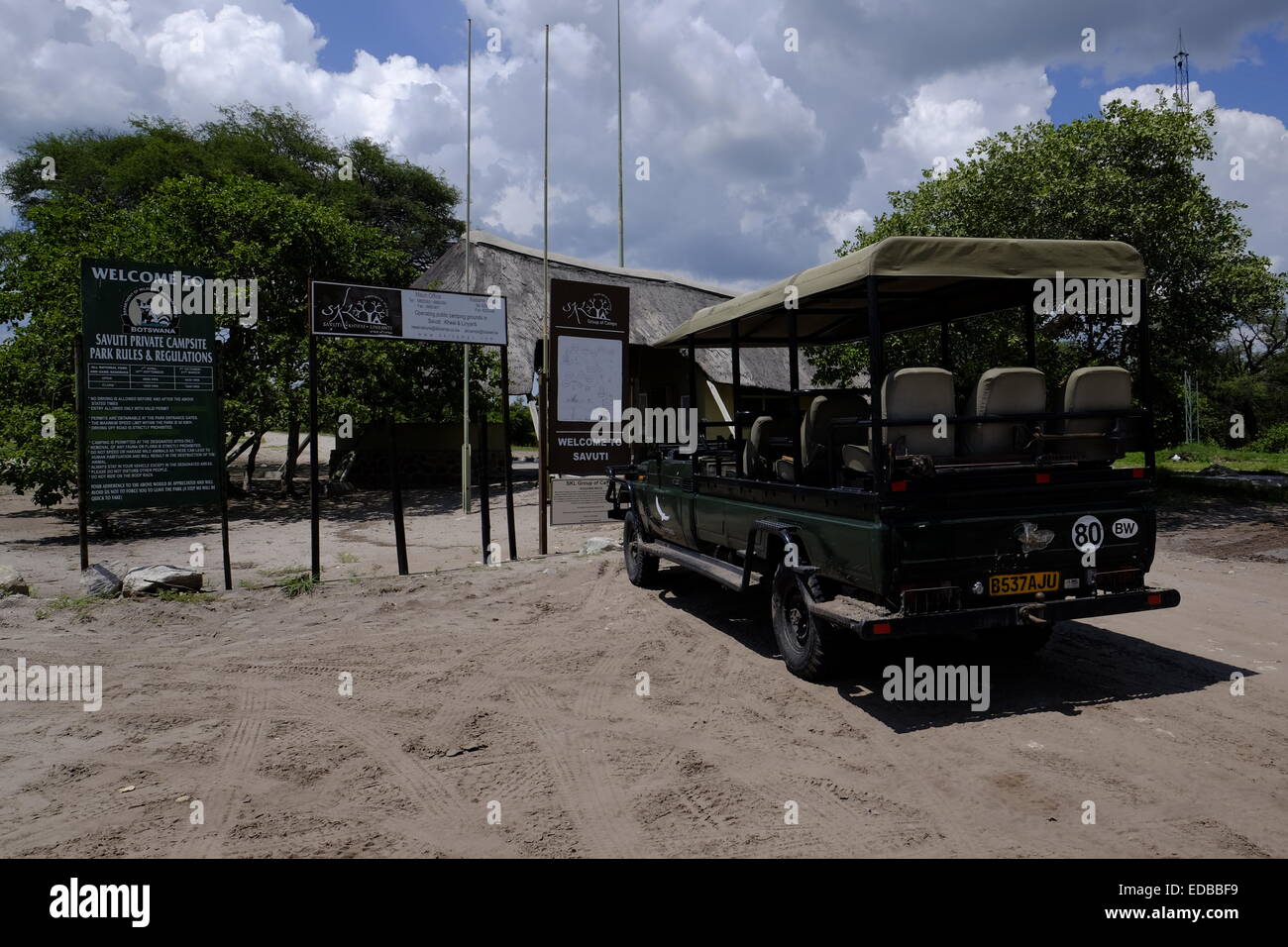 A typical game viewing vehicle used by tourists on safari parked at a ...