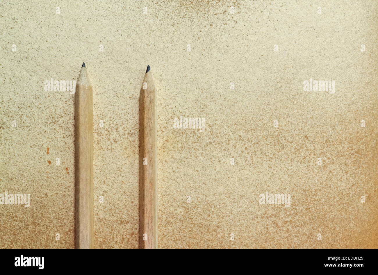 Two vertical pencils on yellow grunge background Stock Photo - Alamy
