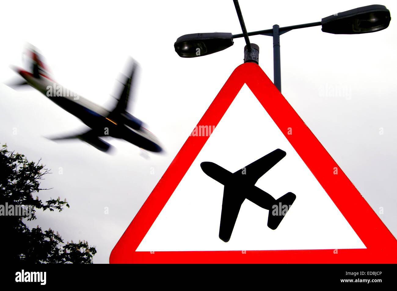 An aeroplane flying above road signs near Heathrow International ...