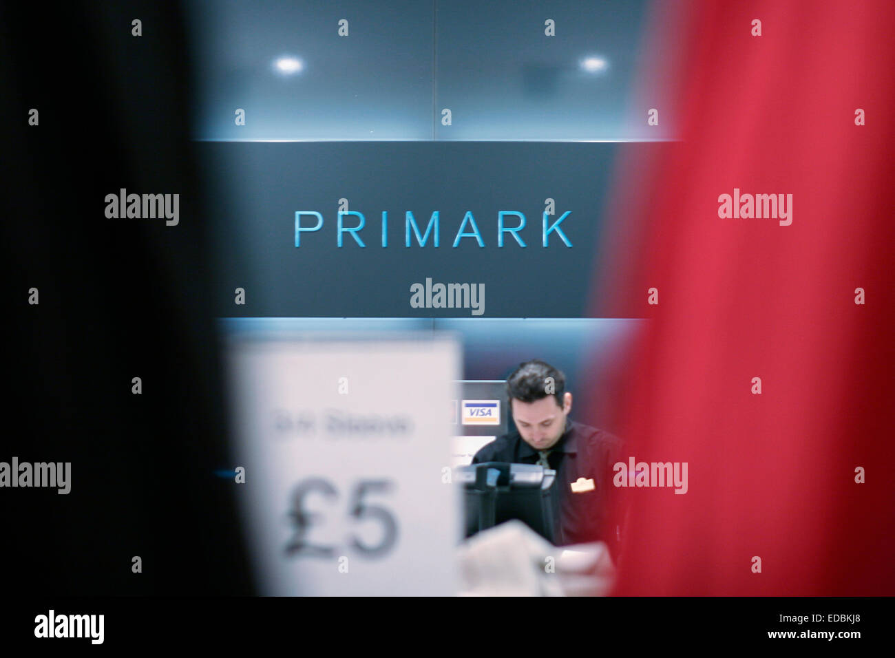 A Primark employee working at a till point Stock Photo - Alamy