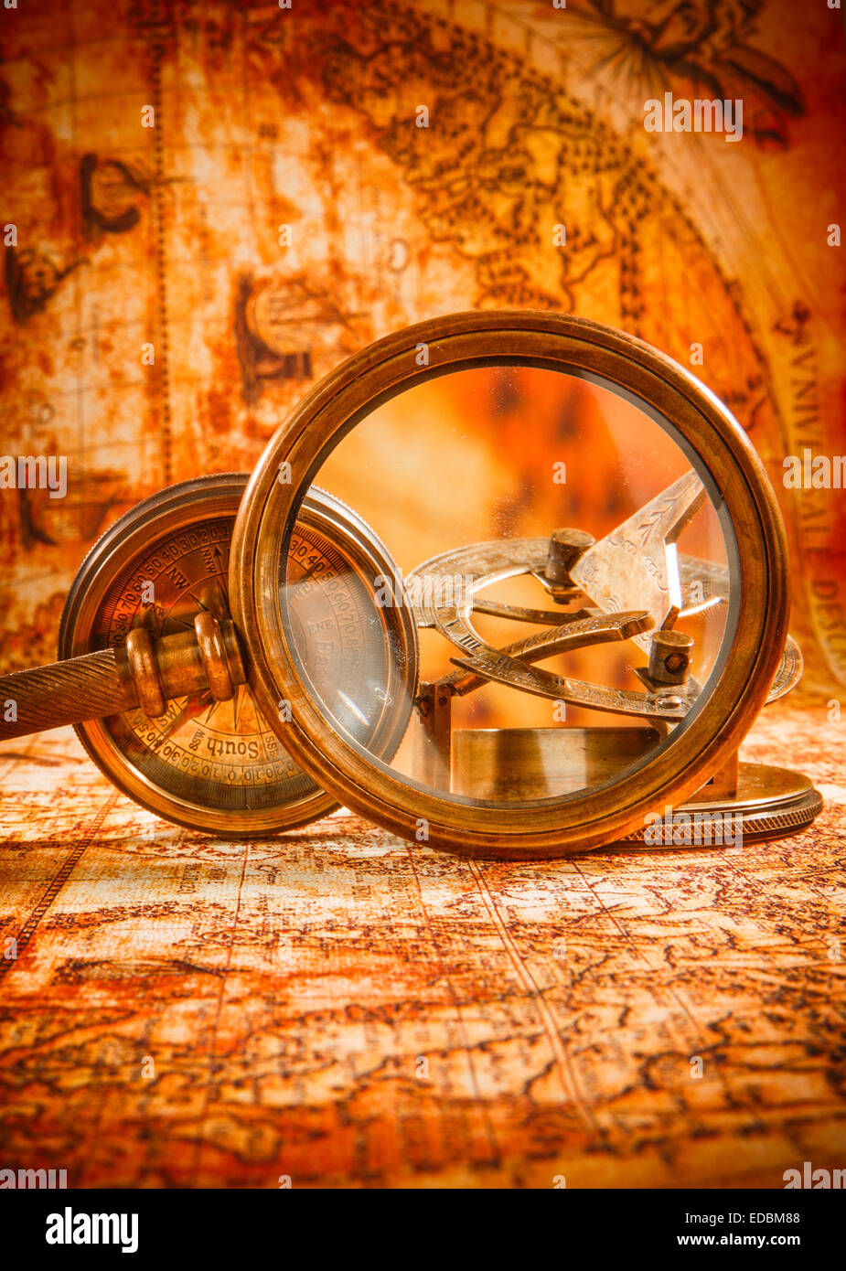 Vintage still life. Vintage magnifying glass lies on an ancient world ...