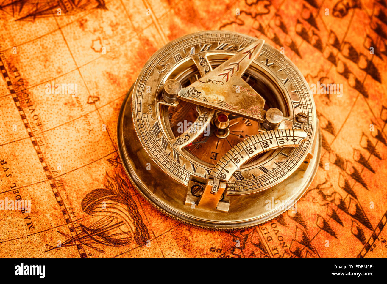 Vintage still life. Vintage compass lies on an ancient world map in ...