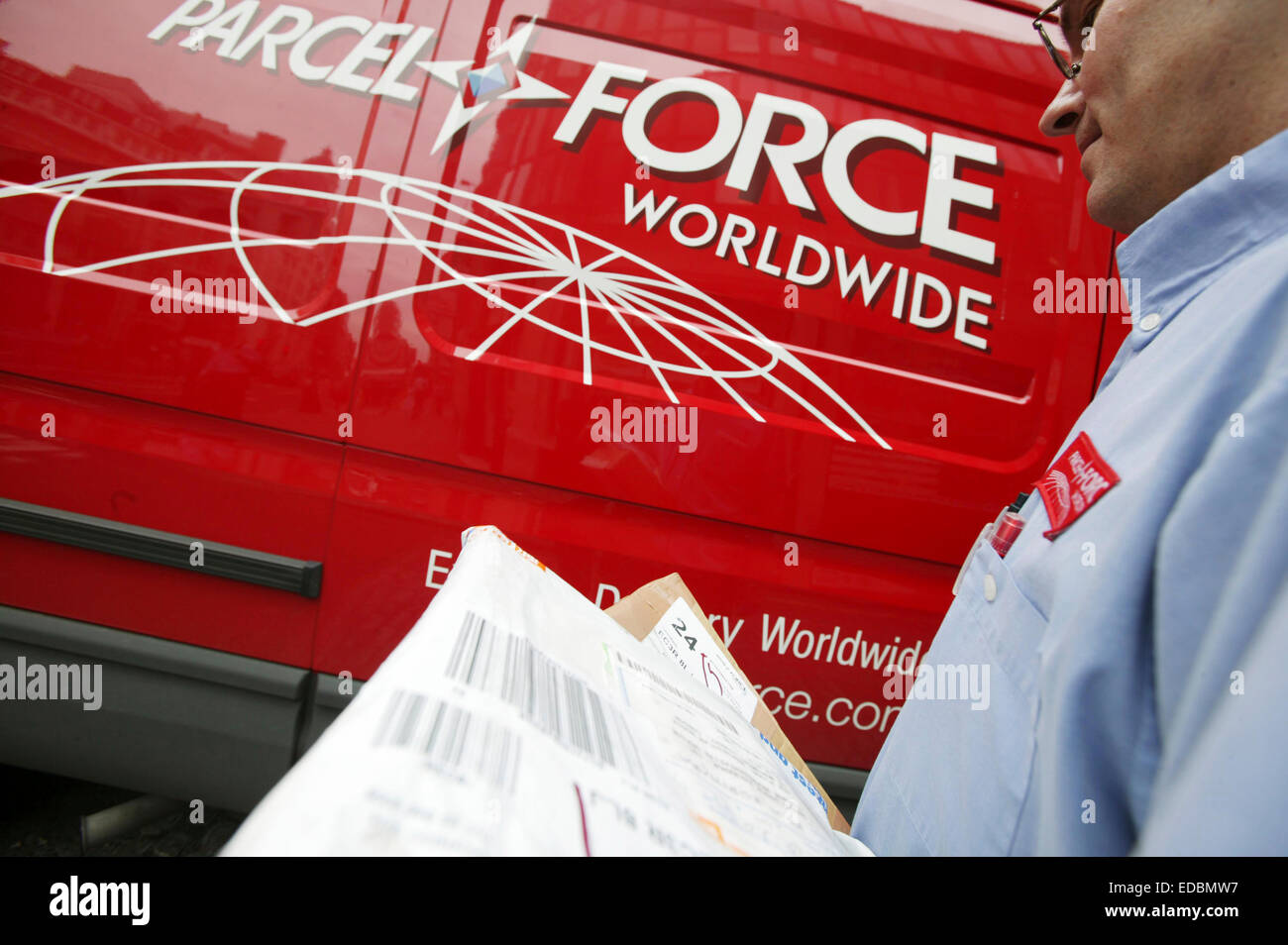 A Parcelforce worker delivering packages in London Stock Photo - Alamy