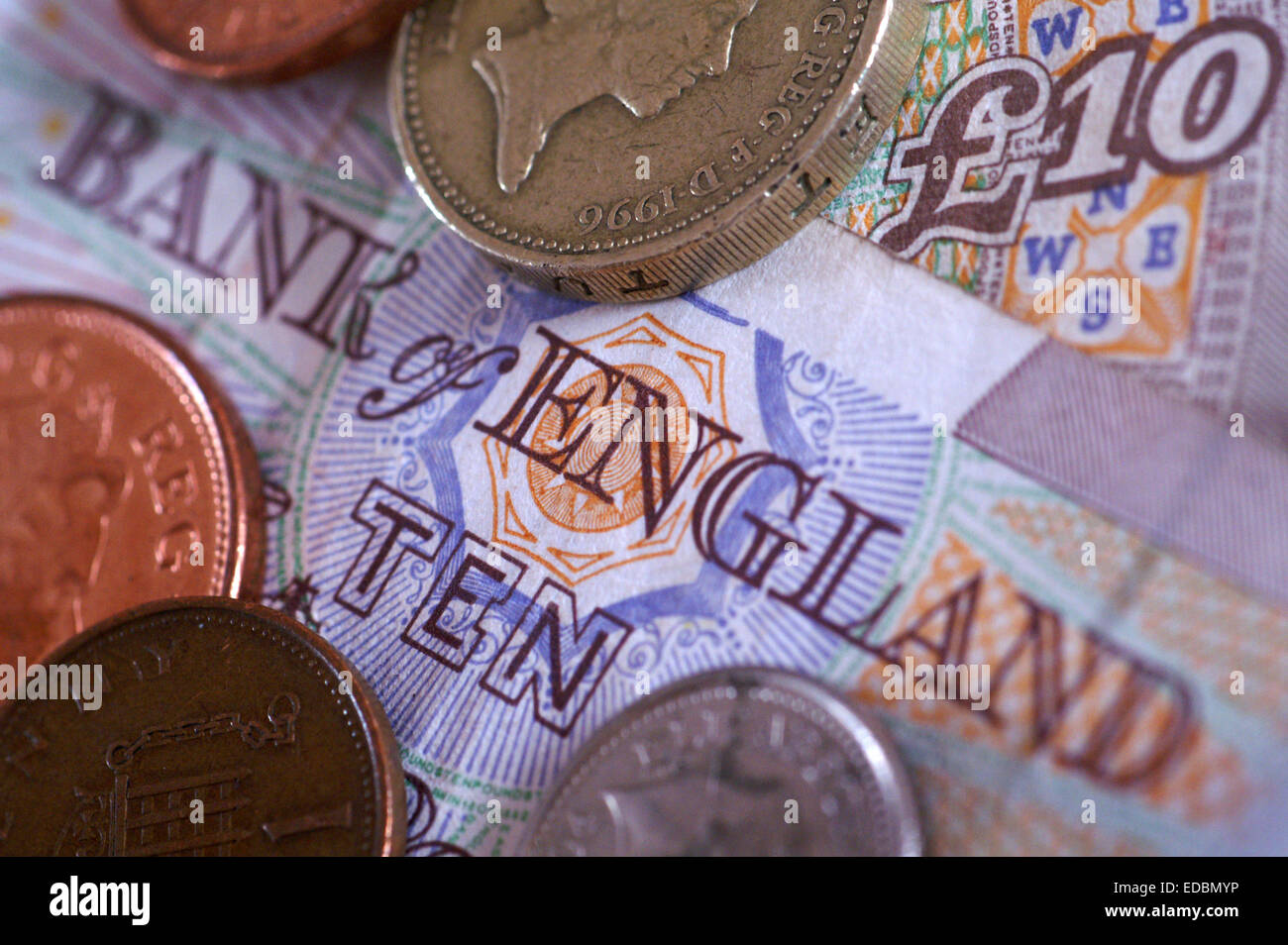 Close-up picture of sterling ten pound notes and coins Stock Photo - Alamy