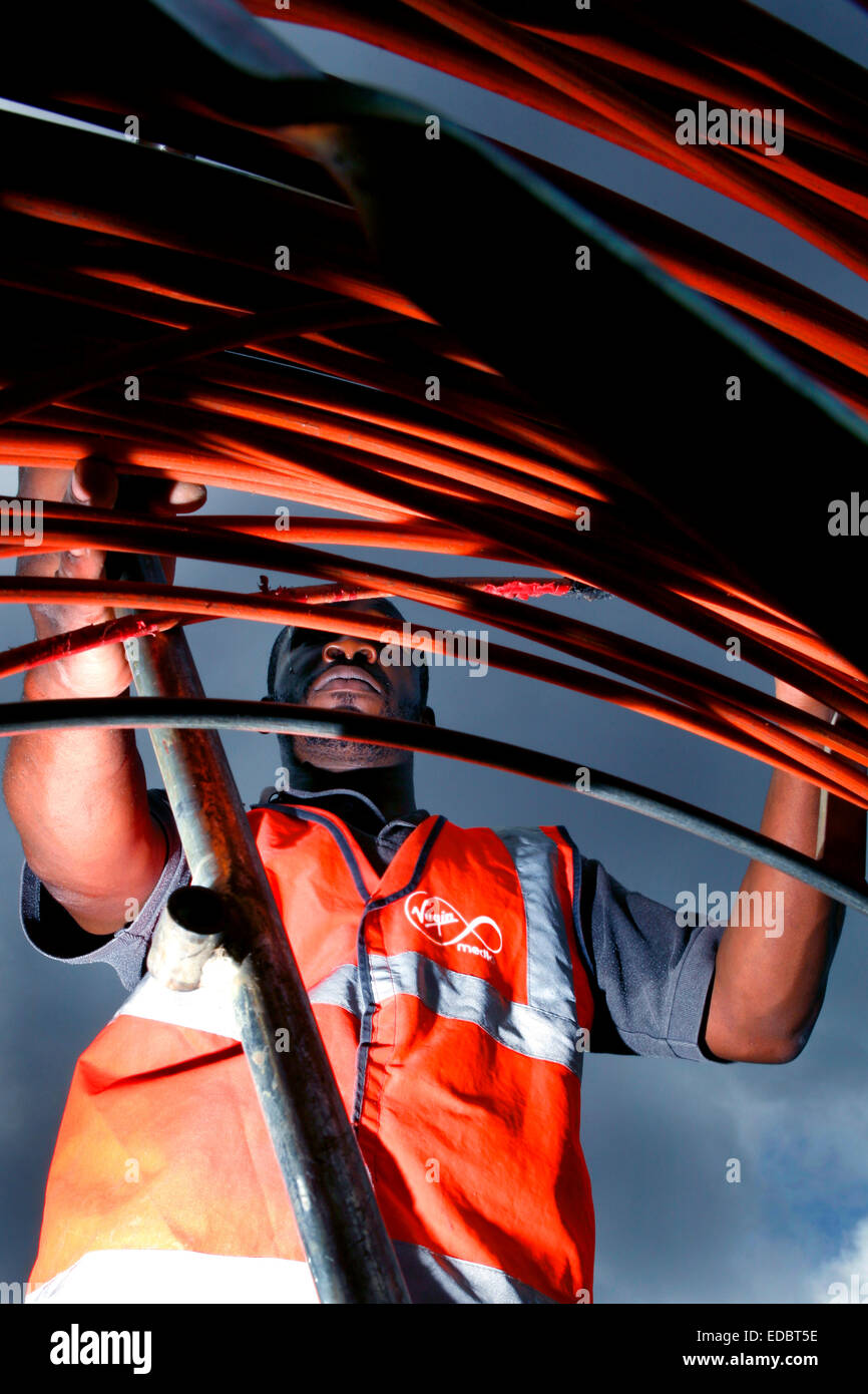 A Virgin Media engineer connecting a house to the Virgin telephone ...