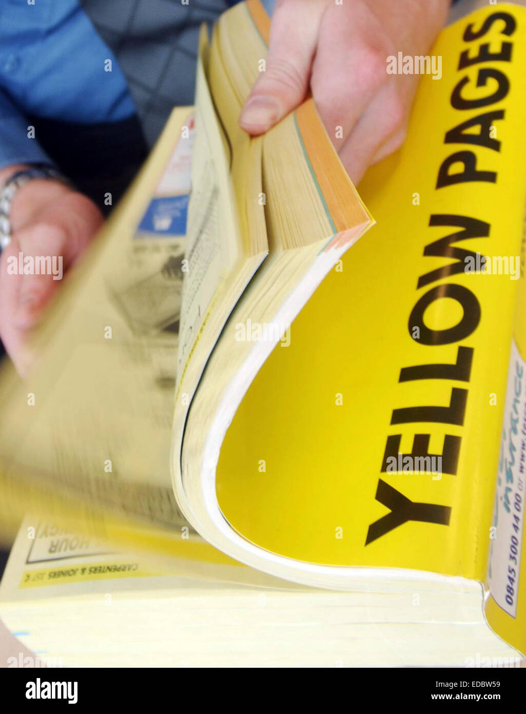 A man using the Yellow Pages telephone Directory Stock Photo - Alamy