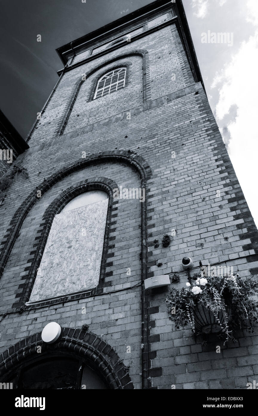 Derelict chimney tower in black and white with cloudy sky above Stock ...