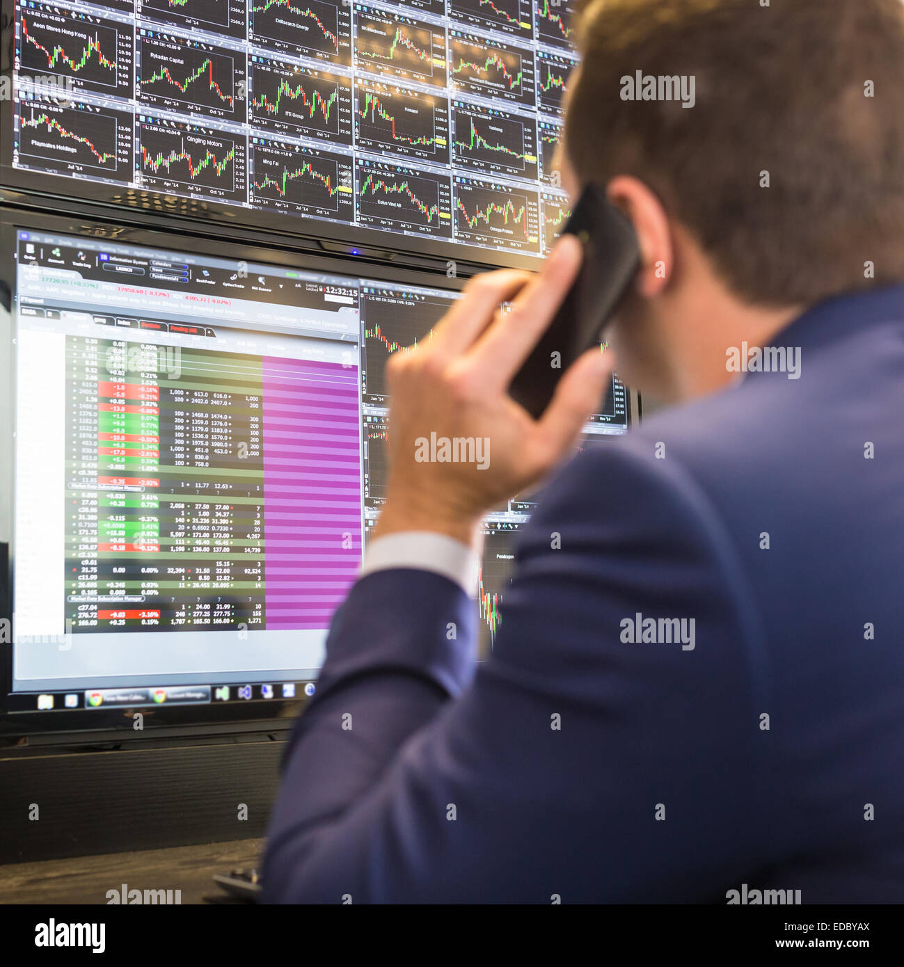 Stock trader looking at computer screens Stock Photo - Alamy