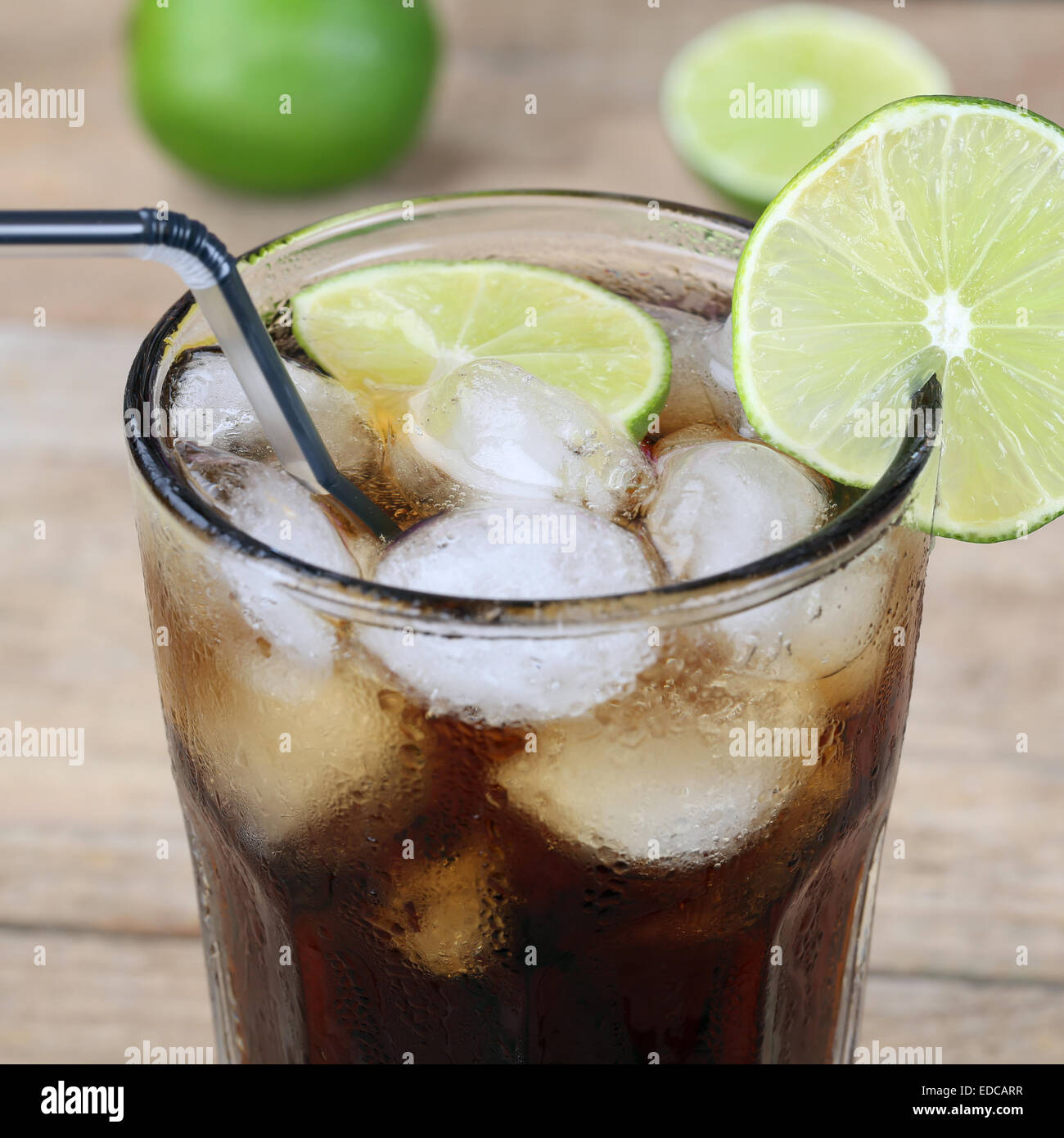 Cola beverage lemonade drink with ice cubes and limes Stock Photo - Alamy