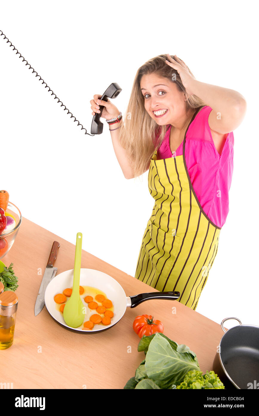 Beautiful woman cooking and speaking at telephone Stock Photo - Alamy
