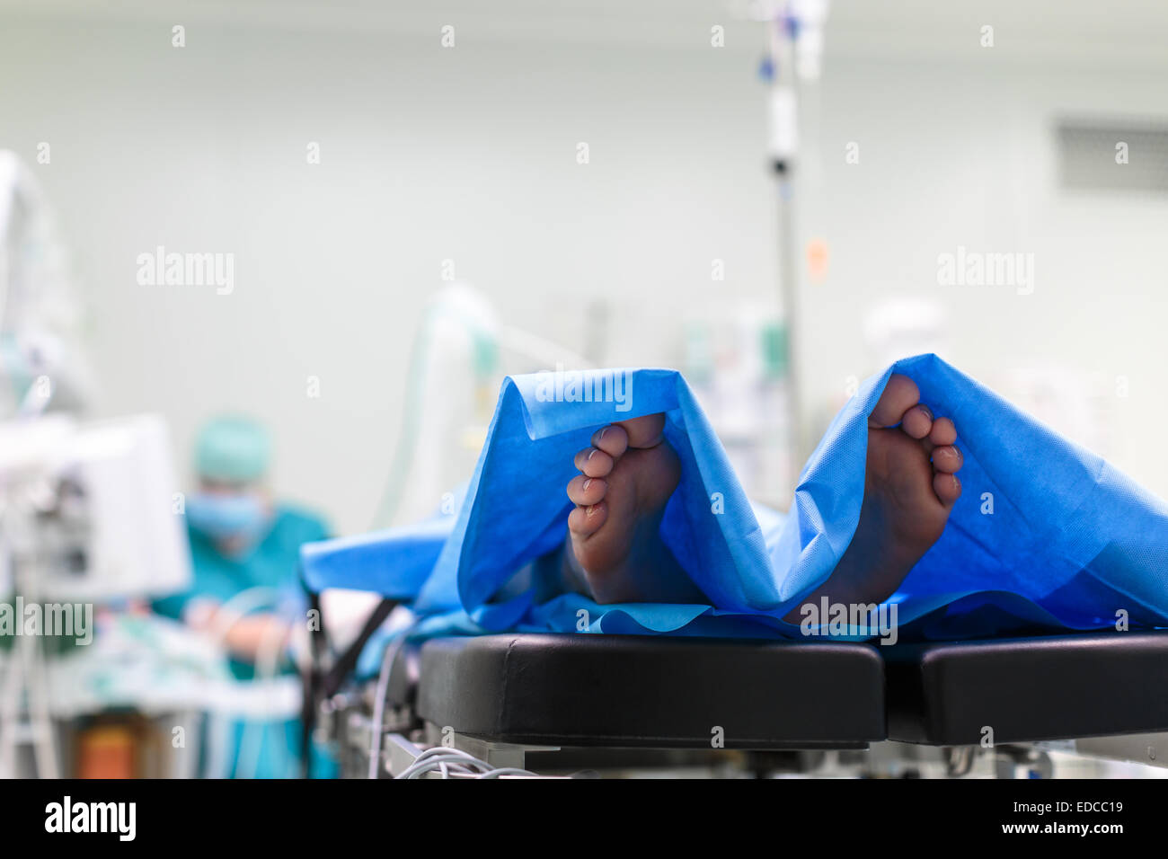 Feet of a patient ready for a surgery in a surgery room (color toned ...