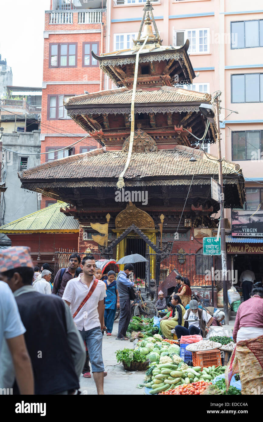 People are shopping a busy street named Ason Tole in front of the ...