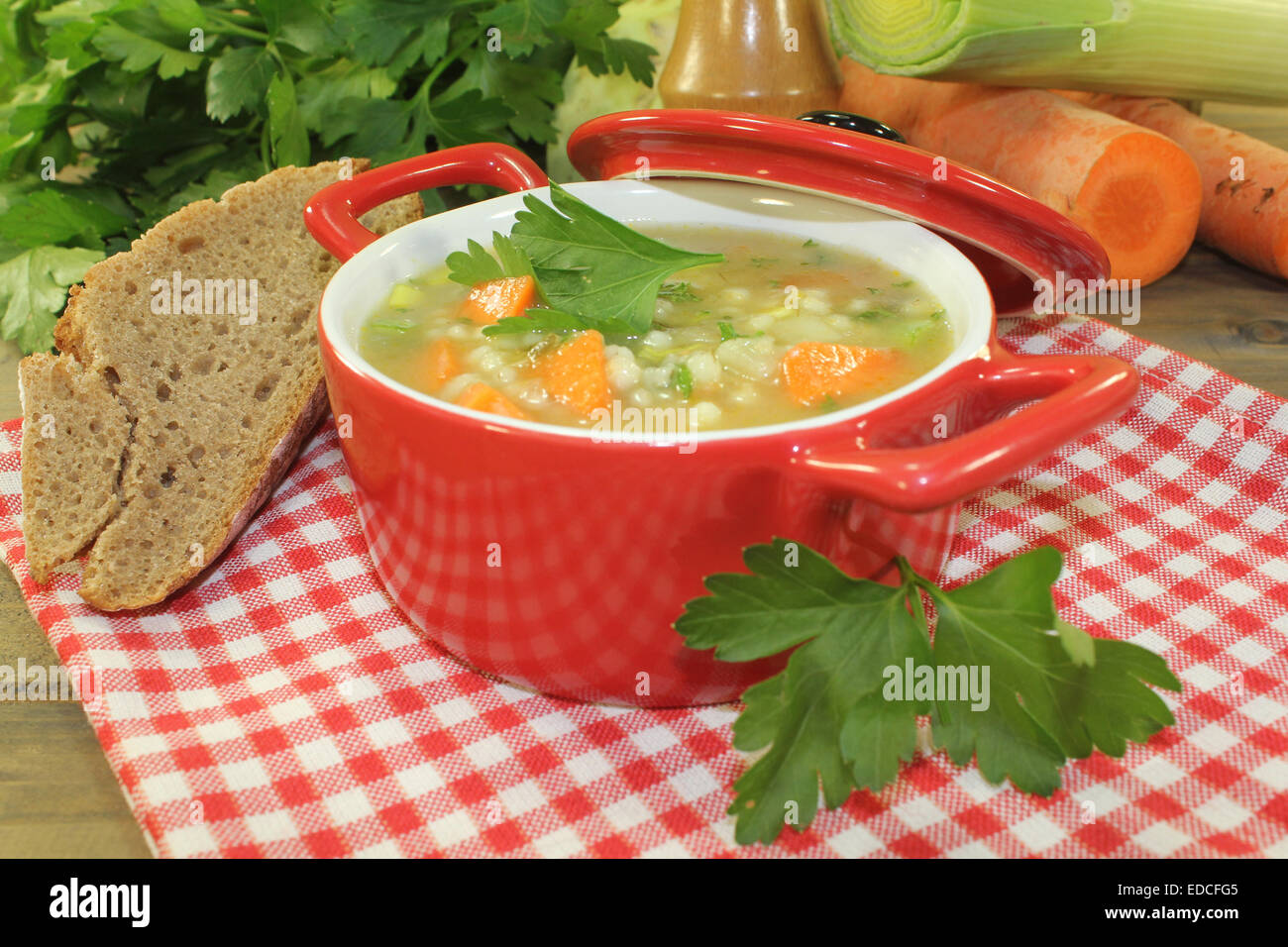 Barley soup with carrots and parsley Stock Photo - Alamy
