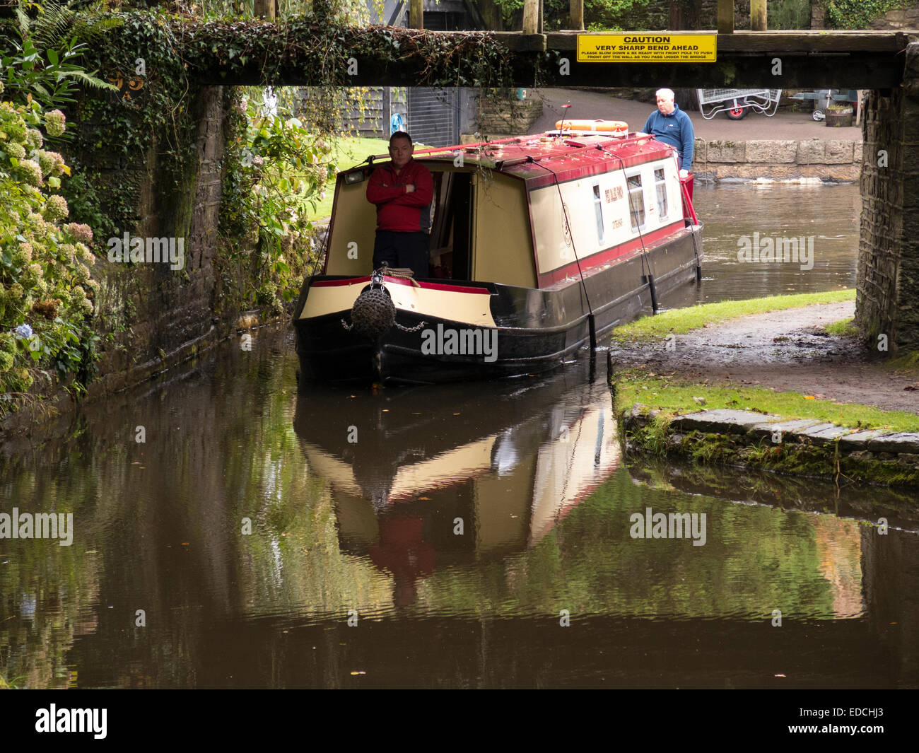 narrow boat goes under a bridge at Llanfoist Wharf,on the Monmouthsire ...