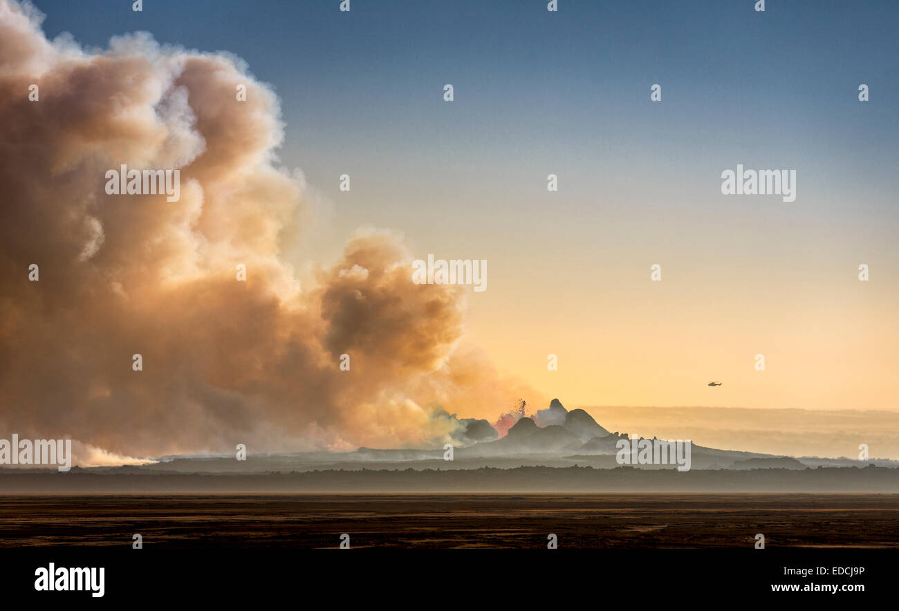 Helicopter flying over the volcano eruption at the Holuhruan Fissure ...