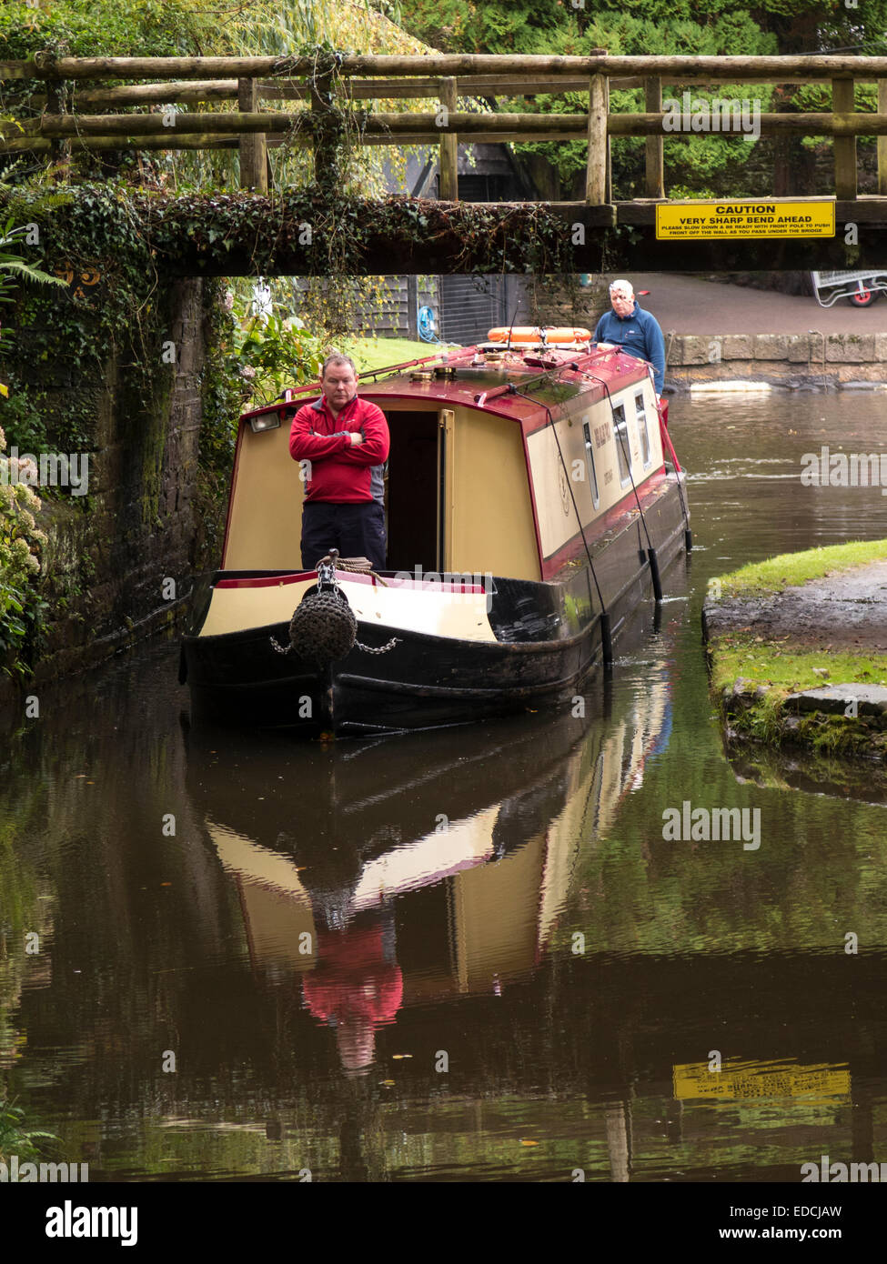 narrow boat goes under a bridge at Llanfoist Wharf,on the Monmouthsire ...