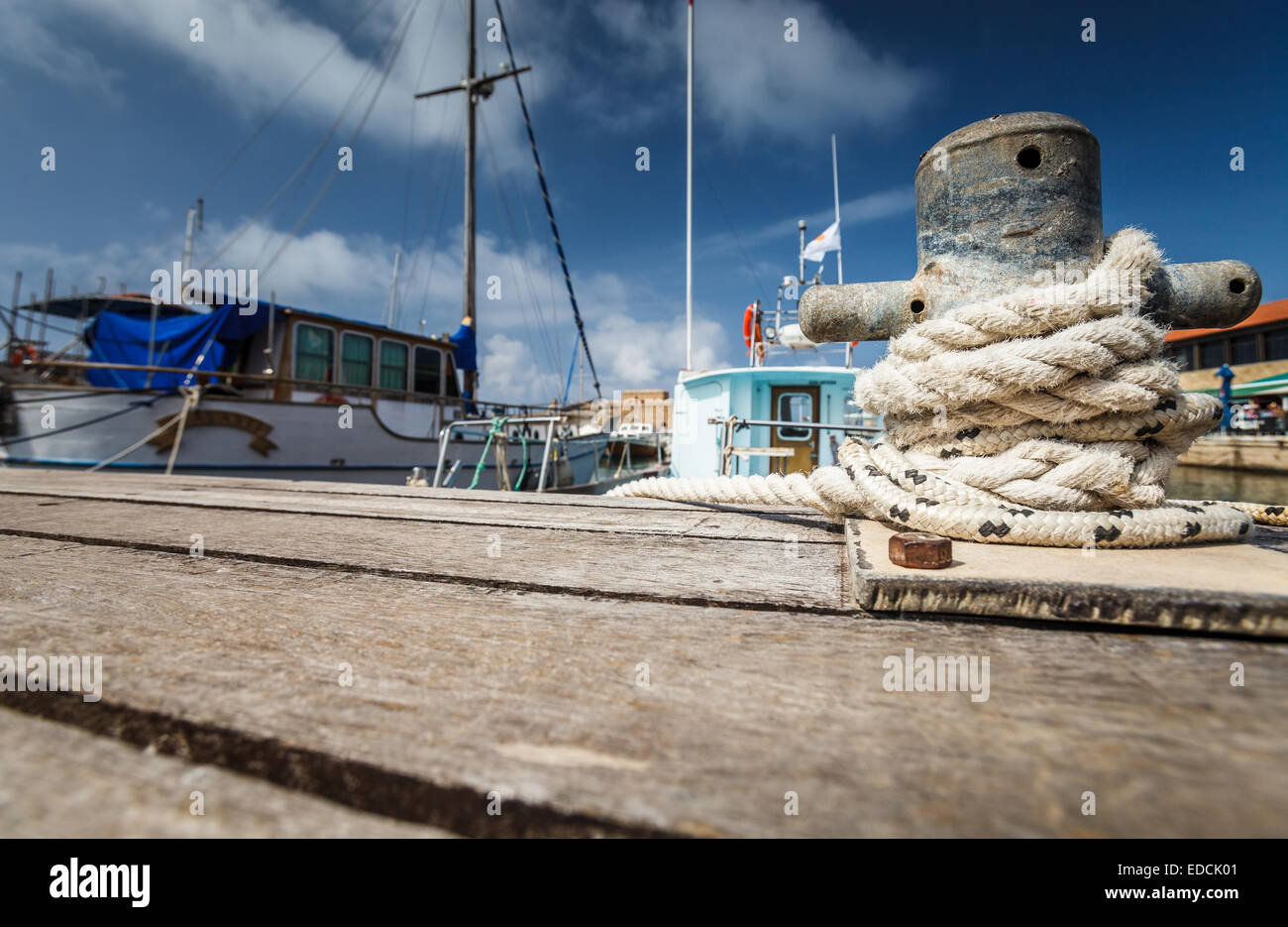 Boat docking point at a marina - rope fixed around a belay in a small ...