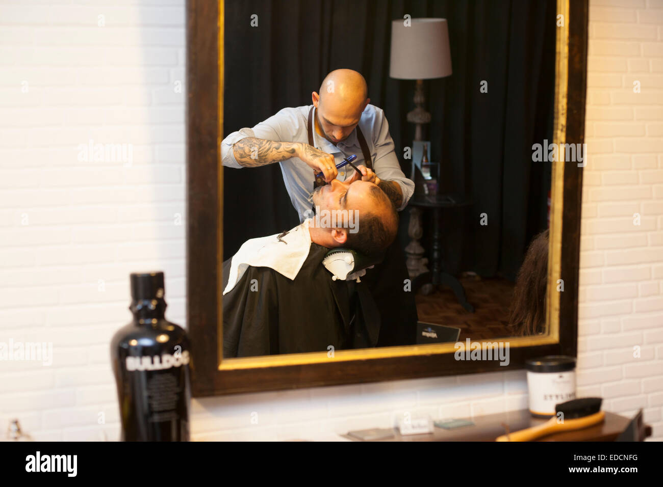 Man getting his beard trimmed with razor Stock Photo - Alamy
