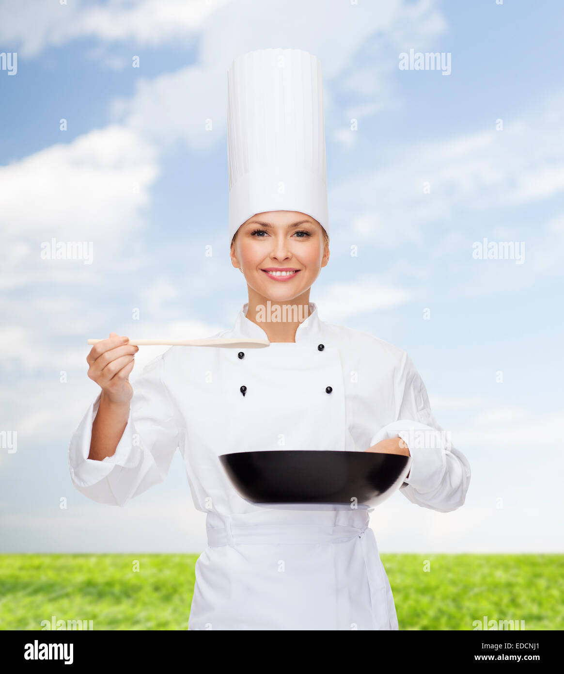 smiling female chef with pan and spoon Stock Photo - Alamy