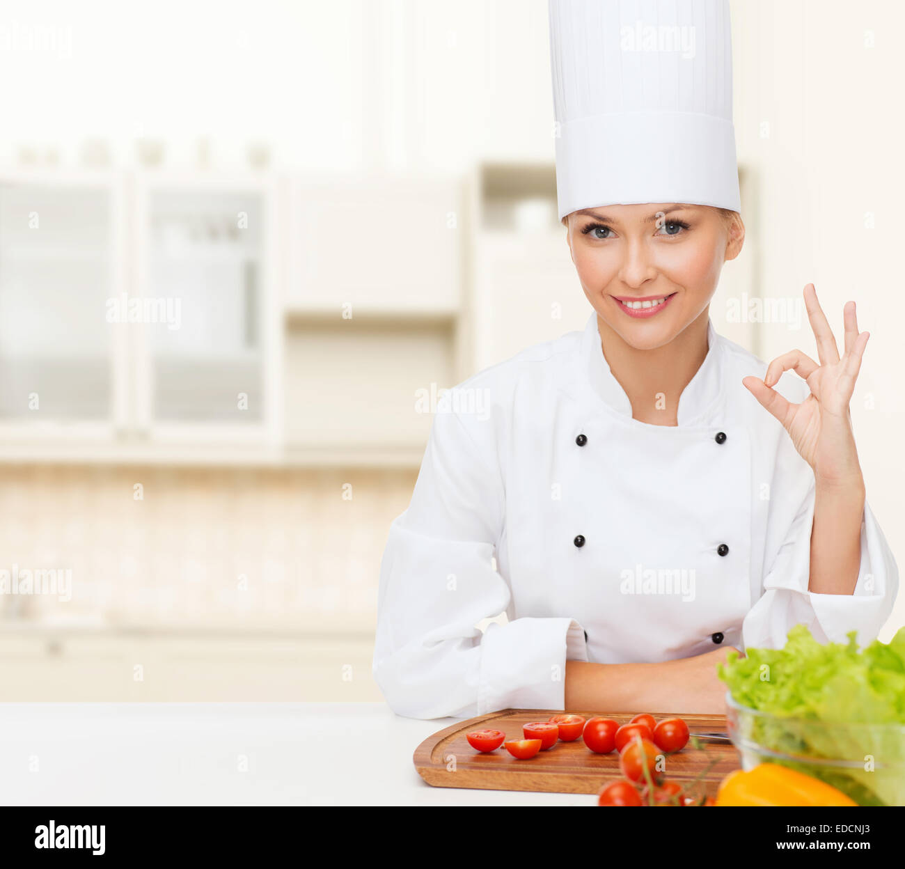 female chef with vegetables showing ok sign Stock Photo - Alamy