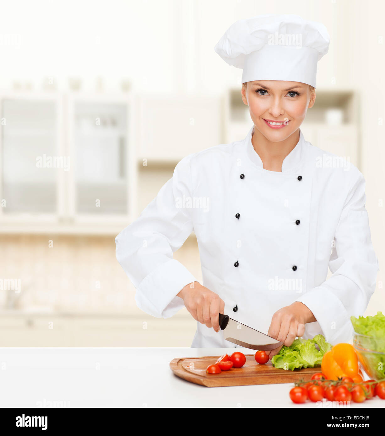 smiling female chef chopping vegetables Stock Photo - Alamy