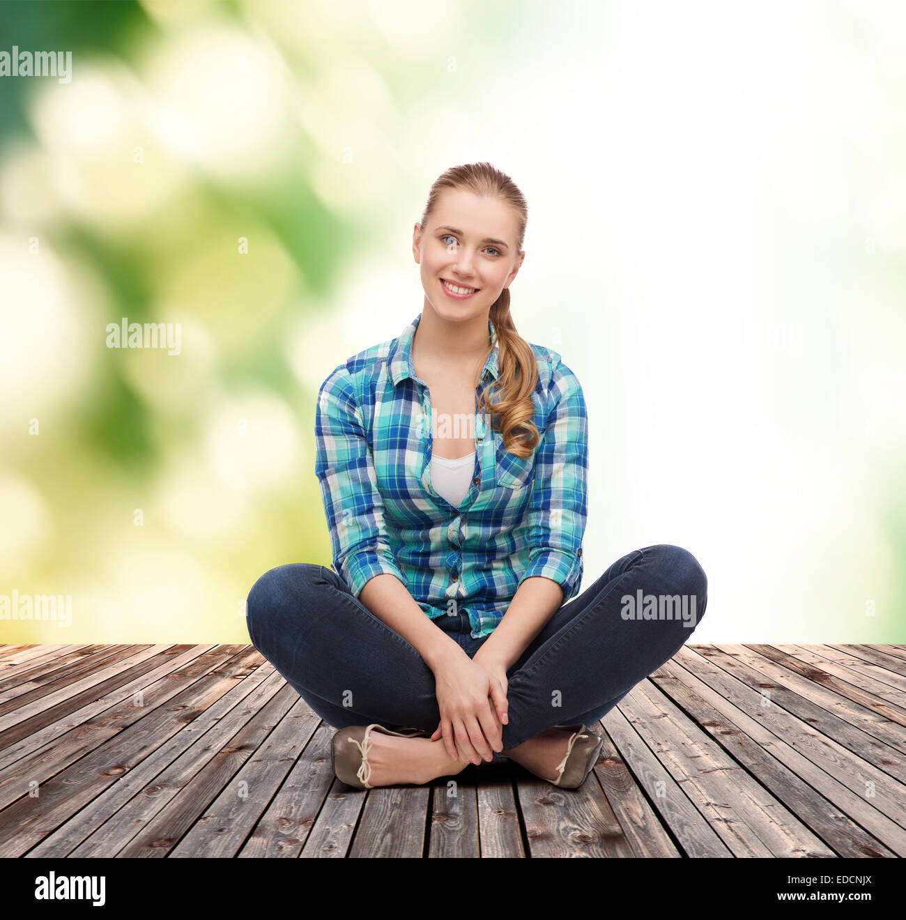 young woman in casual clothes sitting on floor Stock Photo - Alamy