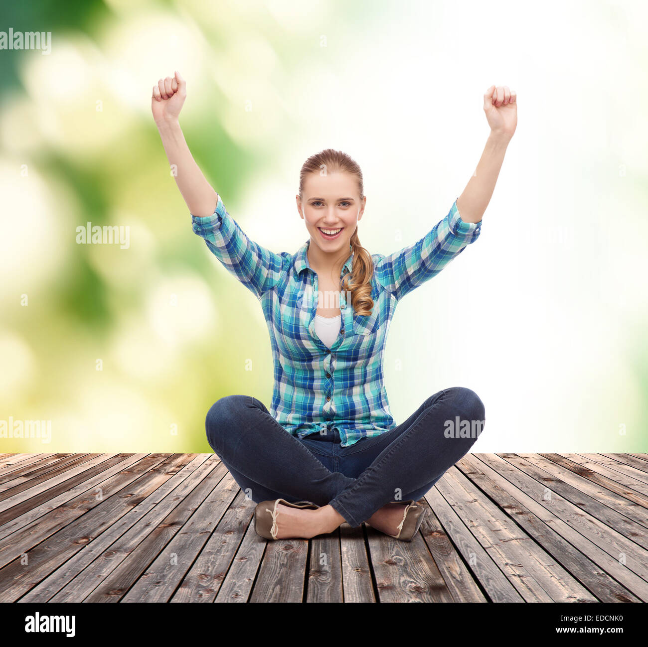 young woman in casual clothes sitting on floor Stock Photo - Alamy