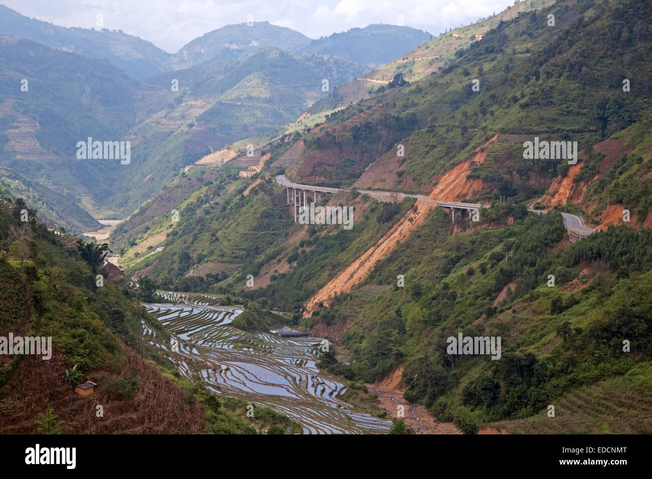 Chinese expressway and terraced rice paddies on hillside in the Yunnan ...