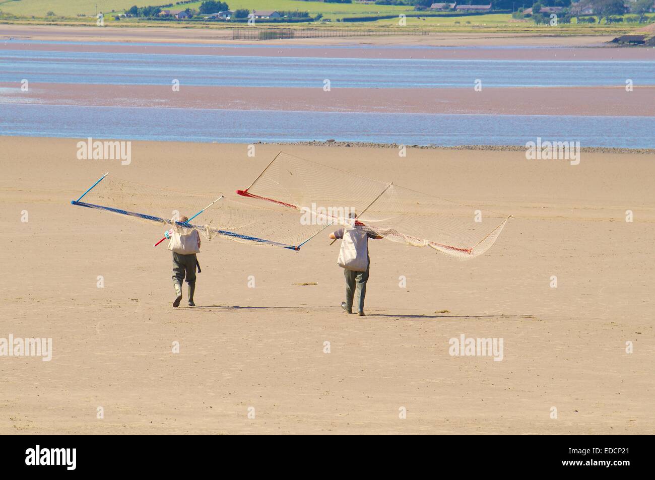 Haaf Net Fishermen fishing walking across the mud flats to the River ...