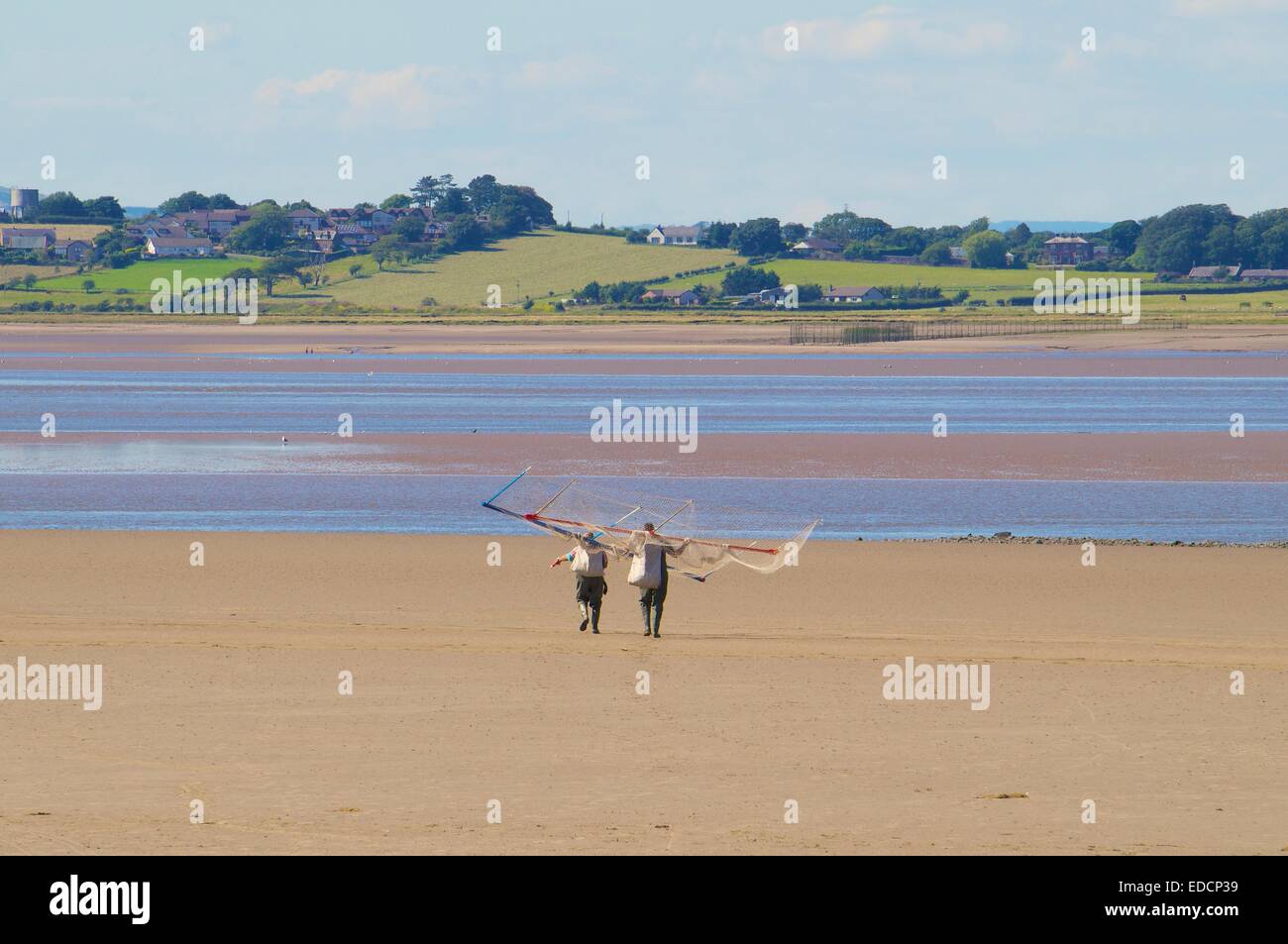 Haaf Net Fishermen fishing walking across the mud flats to the River ...