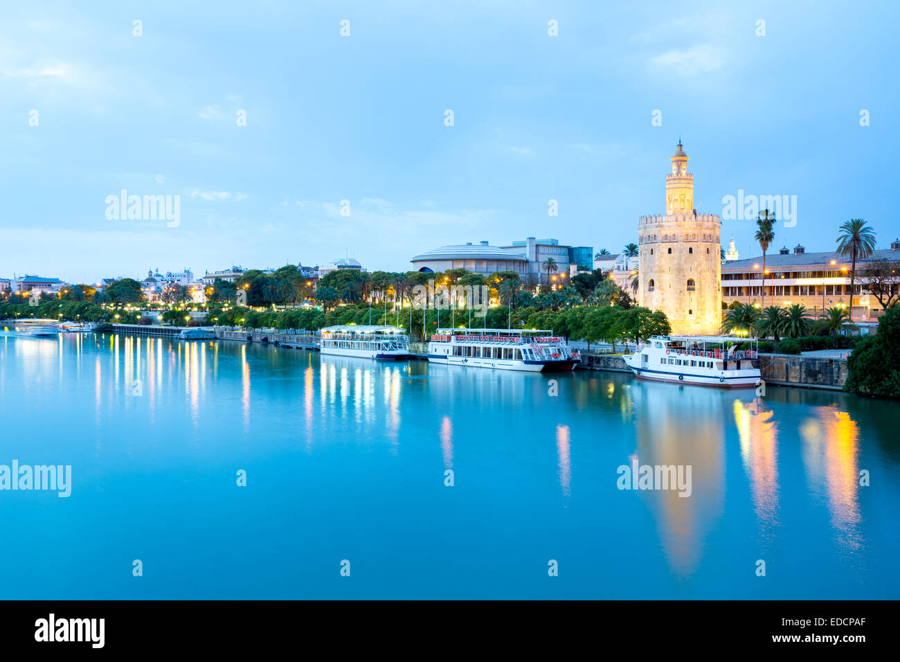 Golden Tower with cityscape and river of Sevilla sunset Seville, Spain ...