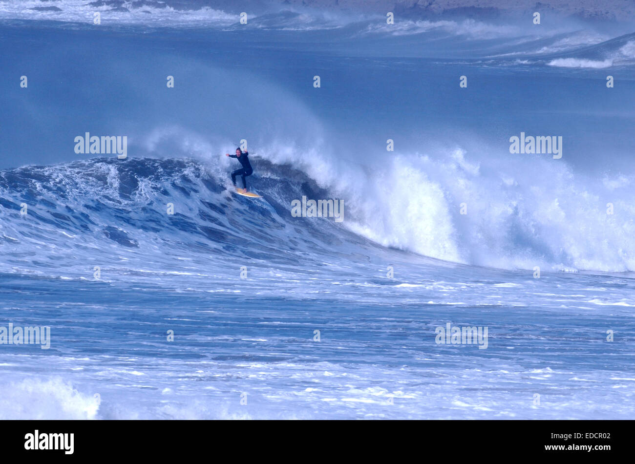 A surfer rides a large Atlantic wave at Croyde beach on the North Devon ...